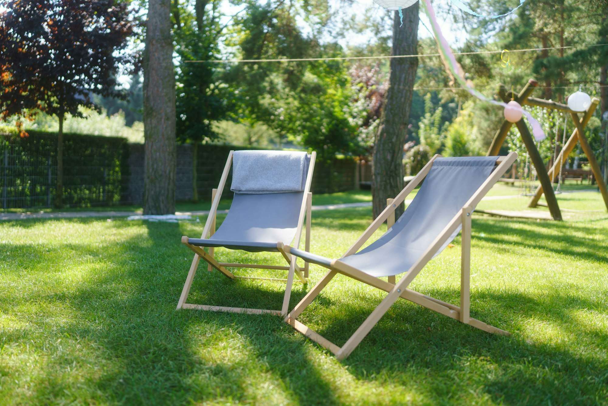 Garden loungers in the garden, in the shade under the trees. Outdoor ...